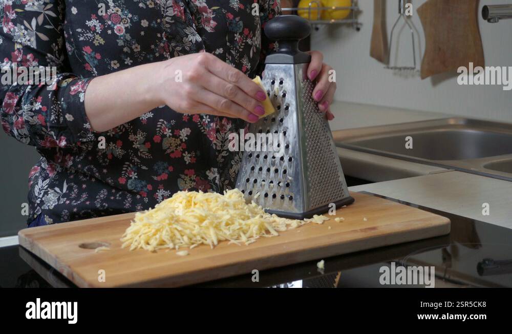 Young woman grating cheese Stock Video Footage - Alamy