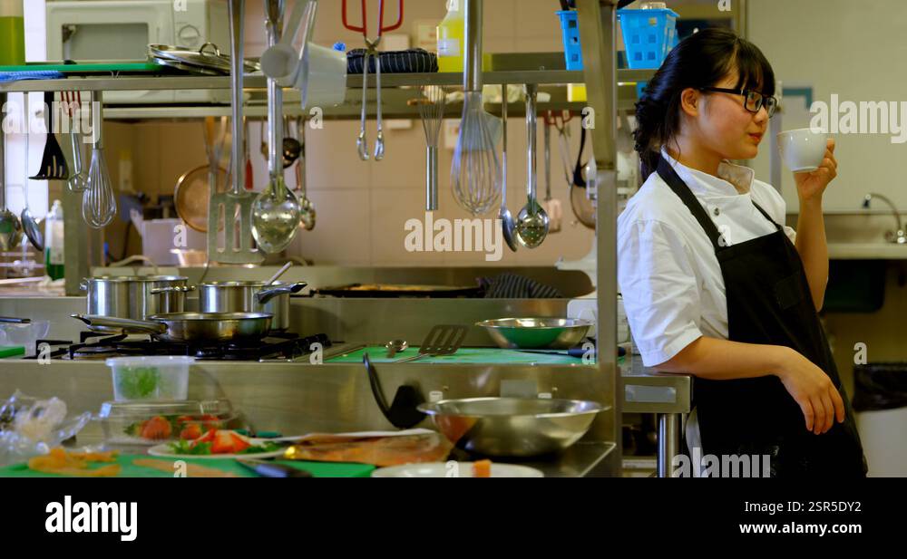 Female chef having coffee in kitchen 4k Stock Video Footage - Alamy