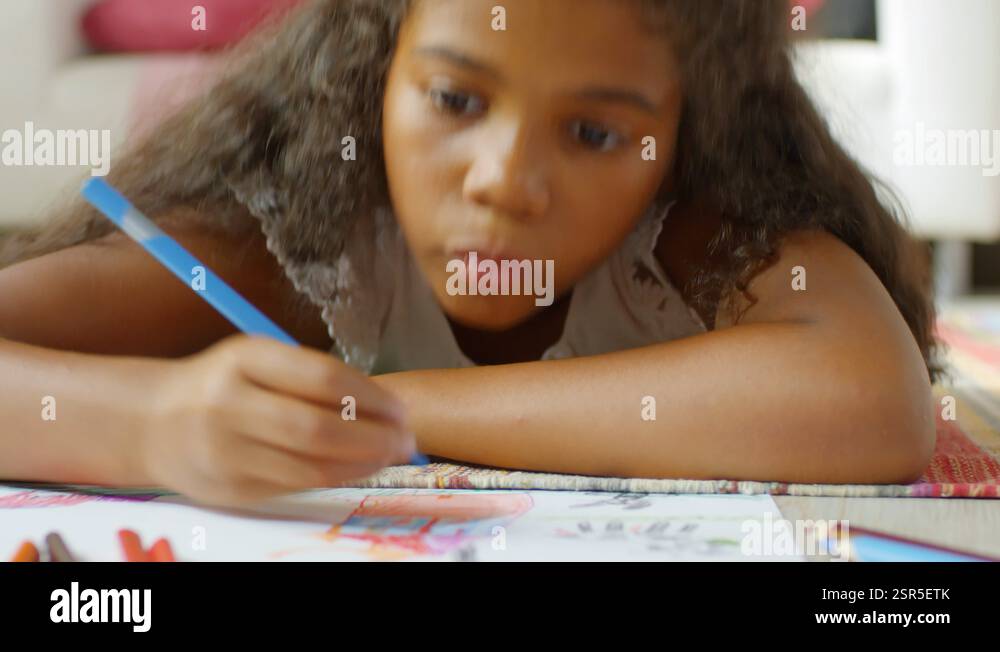 Bored Girl Lying on Floor and Drawing Stock Video Footage - Alamy