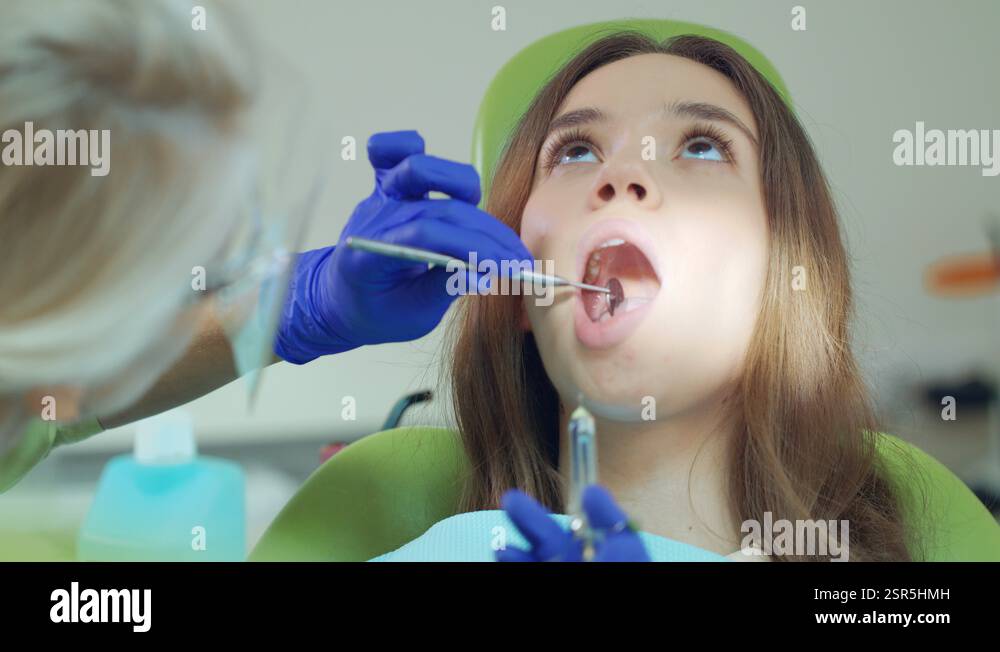 Dentist doing anesthetic injection in patient tooth. Patient in dentist ...