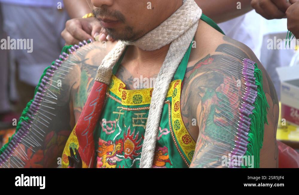 A follower of the Chinese Shrine, pierces cheeks with skewers Stock ...