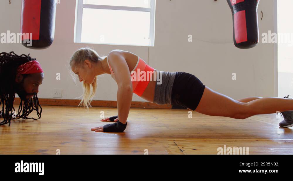 Trainer and female boxer exercising in fitness studio 4k Stock Video ...
