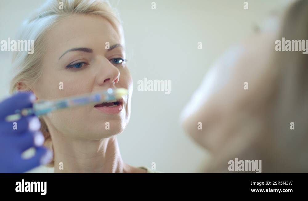 Dentist making anesthesia injection in patient mouth. Woman doctor ...
