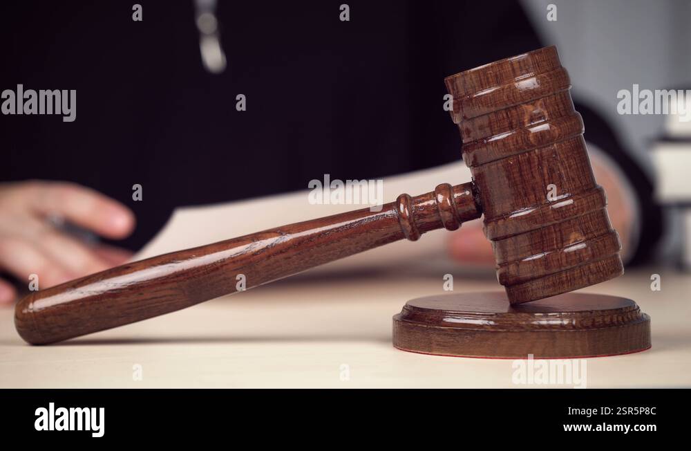 Judge reading papers, checking evidence, working at desk in courtroom ...