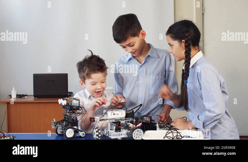 Group of kids choose parts of robotic toys for building robots at ...