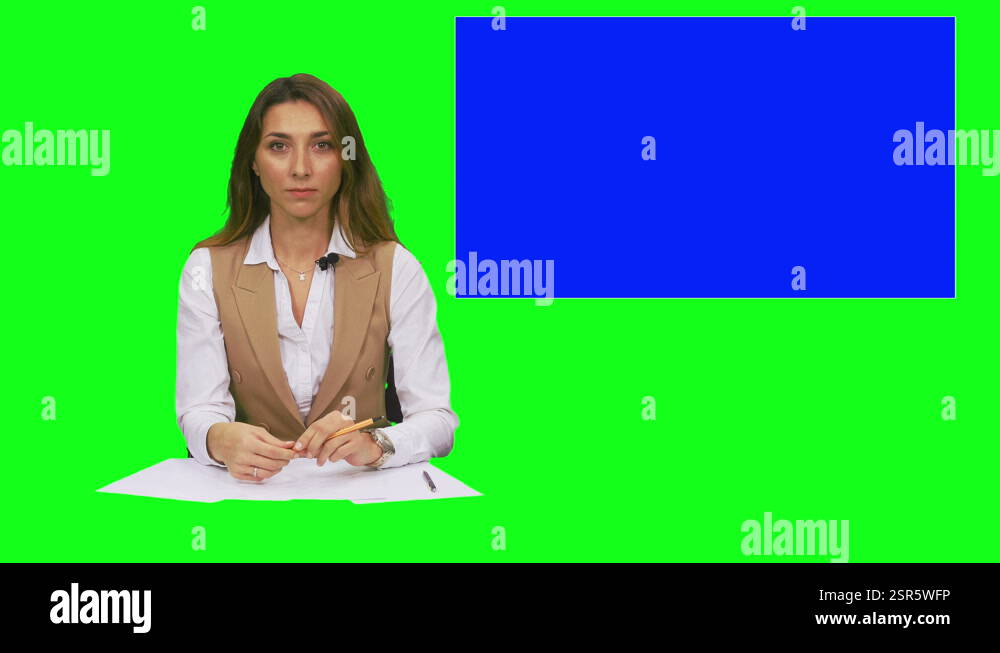 Female news presenter in green studio with blue screen display for ... Female news presenter in green studio with blue screen display for ...