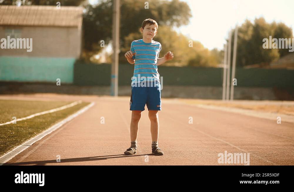little boy playing sports in a stadium a healthy lifestyle. teen boy ...
