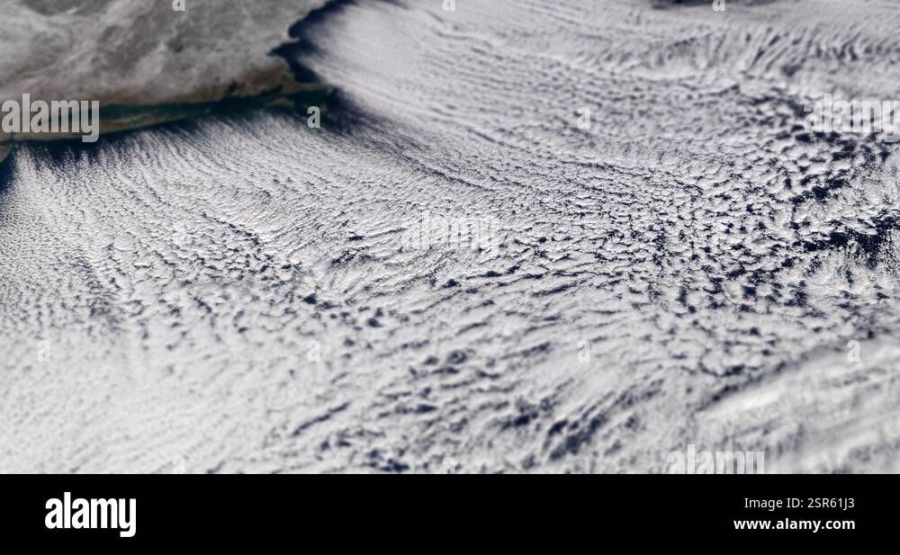 High-altitude aerial tracking shot of clouds, US east coast, with tilt ...