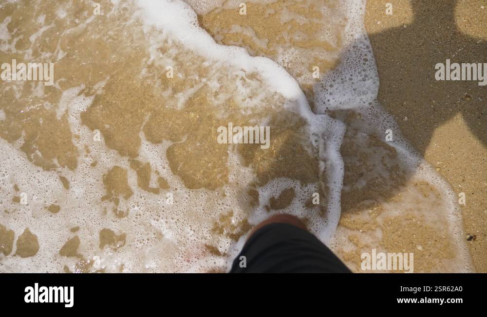 Men's Legs on the sea sand and wave, Relaxation on the ocean beach ...