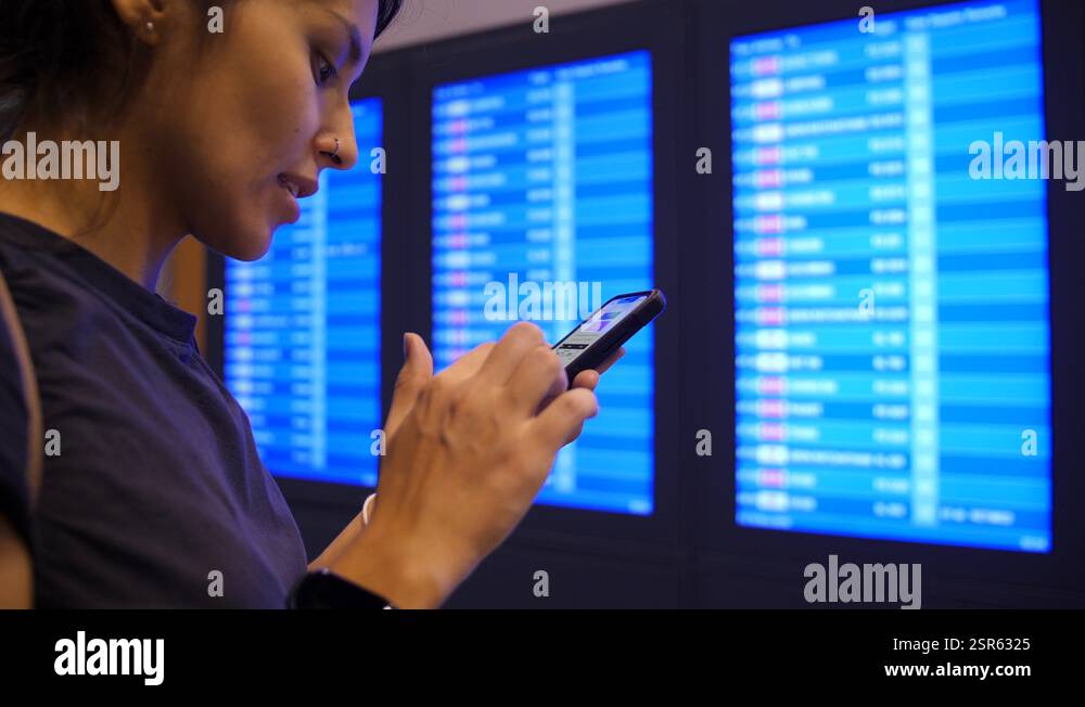 Young Mixed Race Tourist Girl Checking Her Flight Time Using Mobile ...
