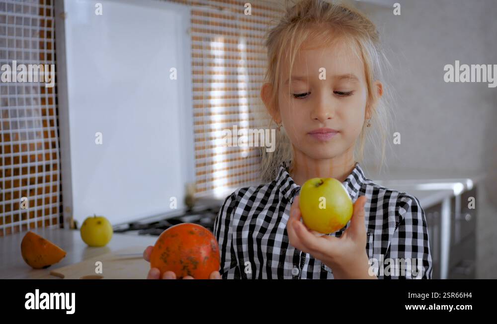 Happy cute girl with fruits in kitchen, kids healthy eating concept ...