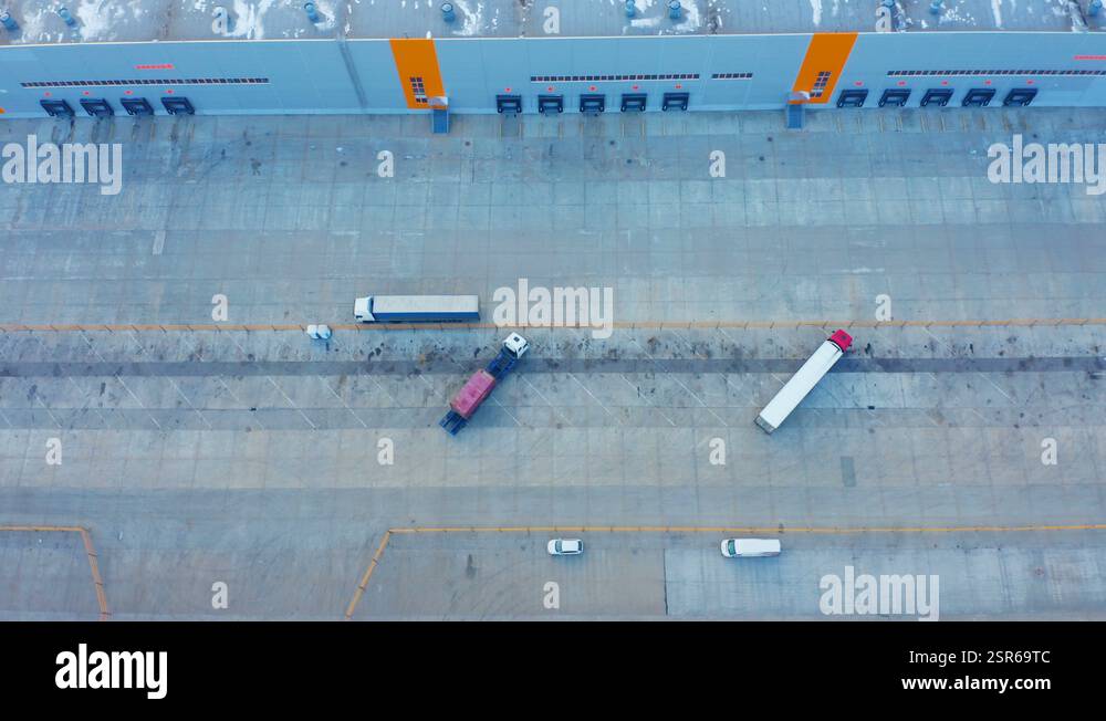 Aerial side view of a big warehouse logistics center with half-empty ...