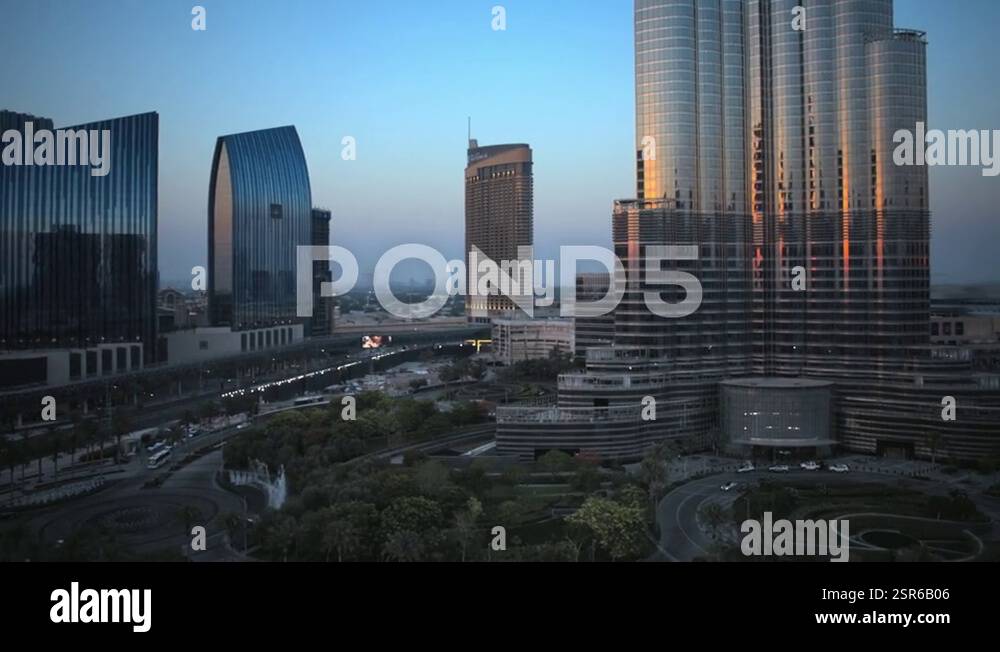 Reverse track back slow pan right at base of Burj Khalifa at 60m ...