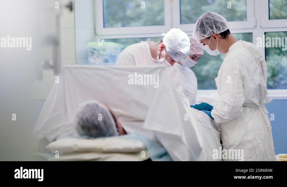 Medical staff with professional surgeon performing operation in ...