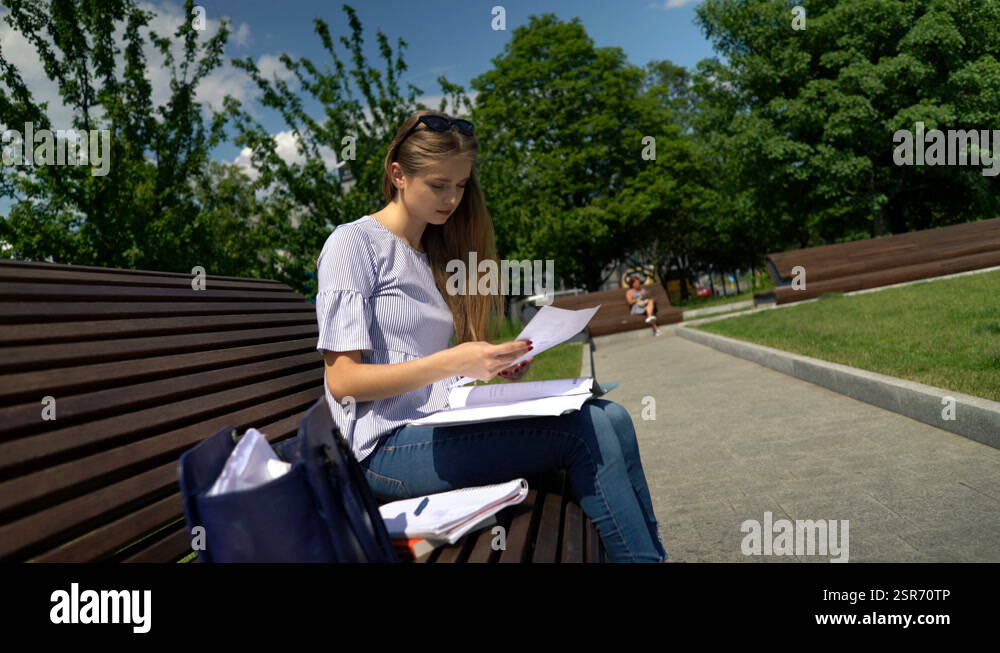 Pretty teenage student girl reading notes in the city Stock Video ...