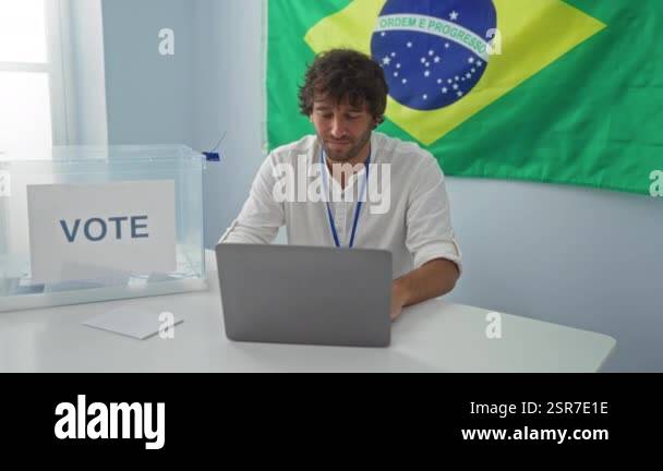 Young hispanic man celebrates victory proudly while using computer in ...