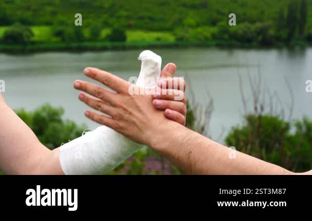 Friendly handshake of two men on nature background in summer time. One ...
