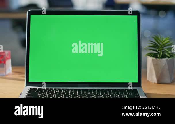 Chroma key laptop placed on modern company workspace closeup. Green ...