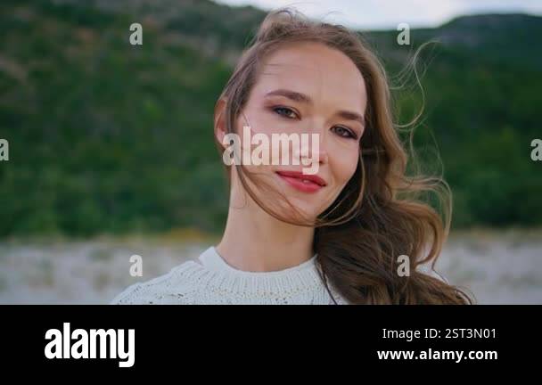 Closeup lady relaxing on nature looking camera with soft smile ...