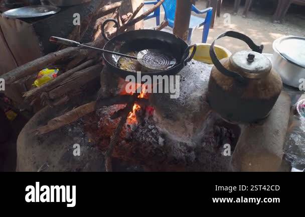 Cinematic shot of traditional Indian cooking of deep-fried pakoras on a ...