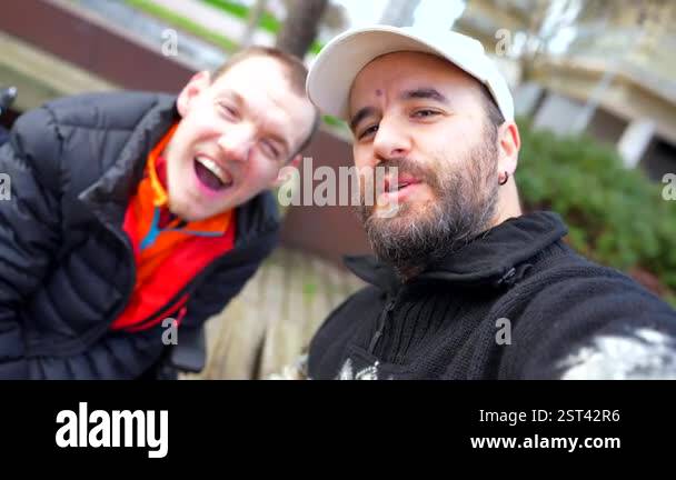 Friends with disability capturing joyful moment together, smiling and ...