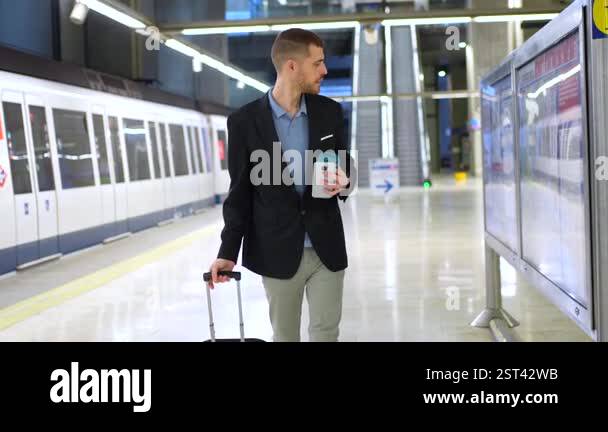 Professional businessman navigating subway station, carrying coffee and ...