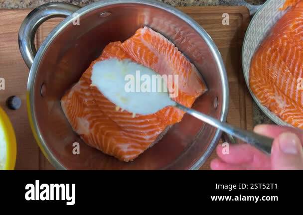 The process of salting salmon fish. The pieces of fish sprinkled with ...