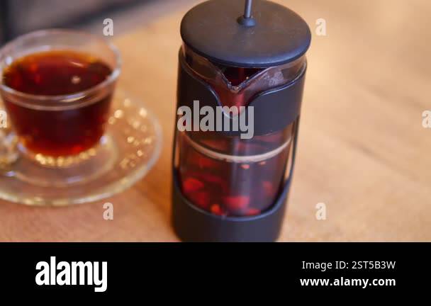 Learn how to brew flavorful tea using a stylish teapot setup Stock ...