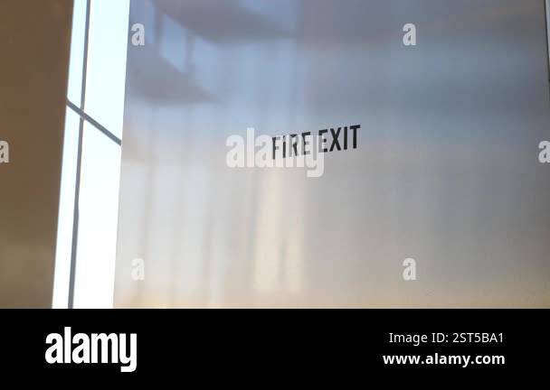 Clear signage indicates fire exit location in a busy building Stock ...