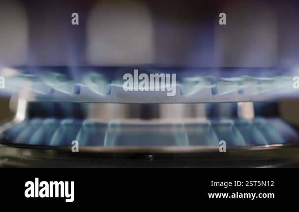 Cinematic macro view of a gas flame on a metal burner. Macro shot of a ...