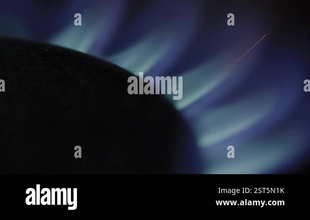 Cinematic macro view of a gas flame on a metal burner. Macro shot of a ...