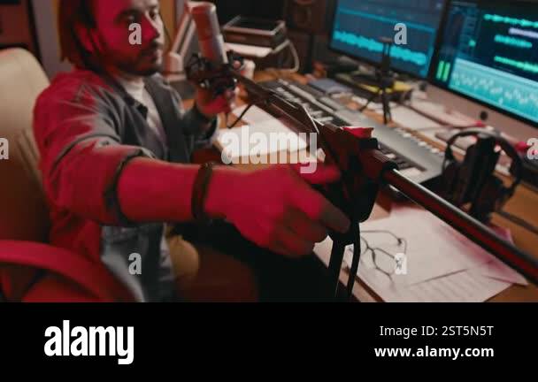 Medium shot of young Caucasian male reggae artist with dreadlocks ...