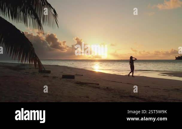Woman walking sunset tropical beach against bright colorful sky. Slim ...