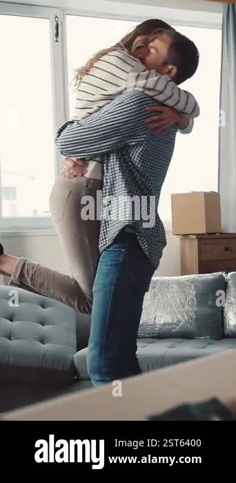This video captures intimate moments of a couple in a cozy living room, expressing affection ...