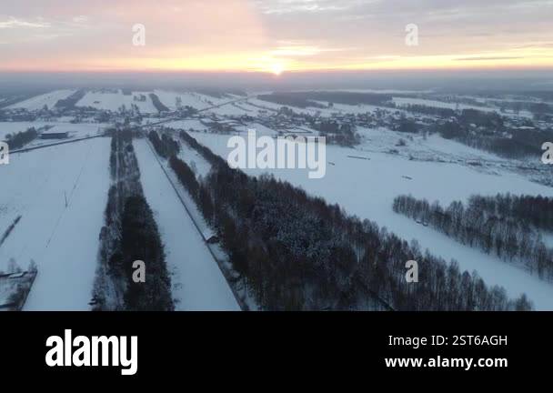 Snow-covered village and fields from above Stock Video Footage - Alamy