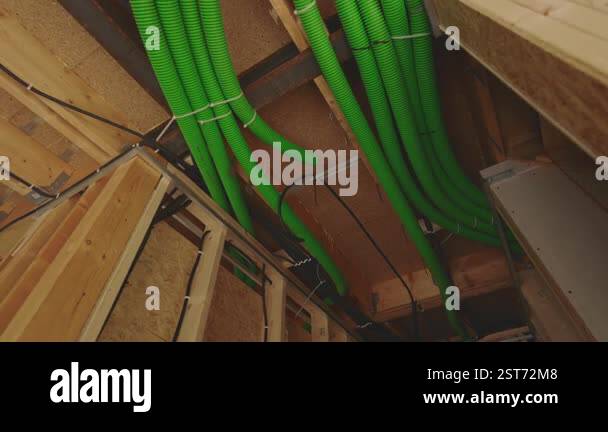 Construction workers install air ventilation duct within the ceiling ...