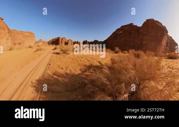 Aerial view on off road vehicle driving through the desert landscape of ...