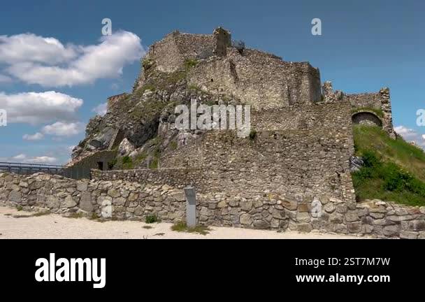 A stunning view of an ancient stone castle atop a rocky hill ...