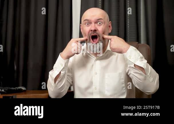 Man laughing and acting irrationally from overworking in home office ...