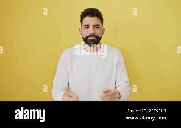 Confident young man, standing with a sneaky smile, doing a money ...