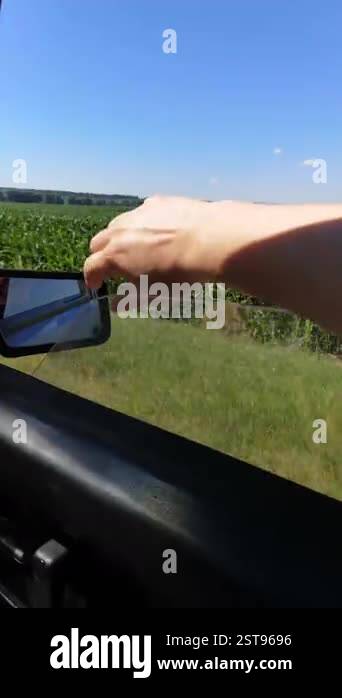 First-person view of a female passengers hand reaching out of a fast ...