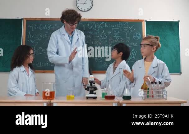 Teacher giving high five to happy children to celebrate discovering ...