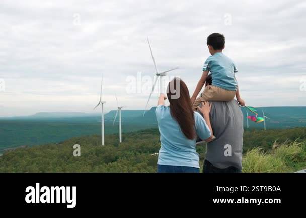 Concept of progressive happy family enjoying their time at the wind ...