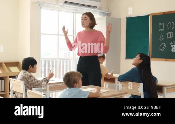 Caucasian teacher teaching and explaining theory to multicultural ...