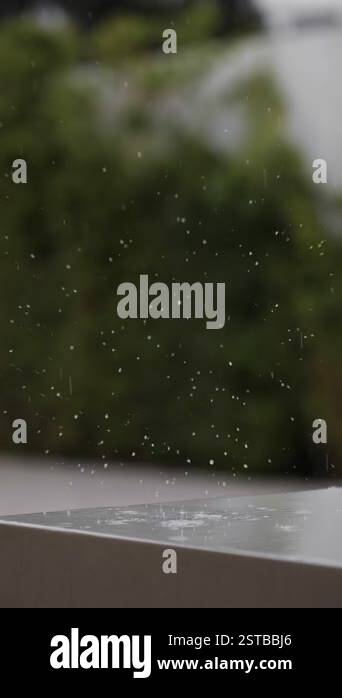 Dynamic capture of heavy rain hitting a flat surface, creating ...