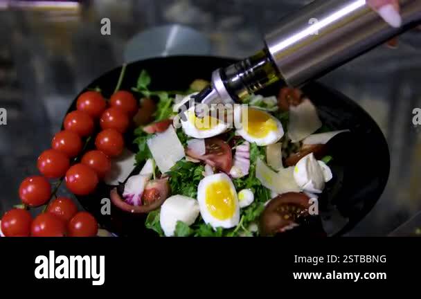 Rotating salad bowl with Salad of fresh vegetables and tuna, tomatoes ...