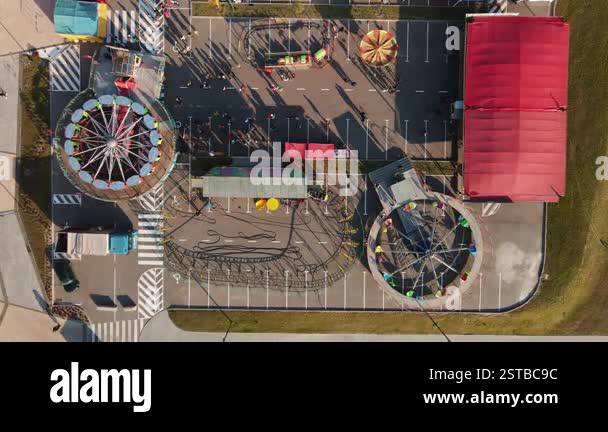 A top-down aerial view of an amusement park featuring Ferris wheels ...