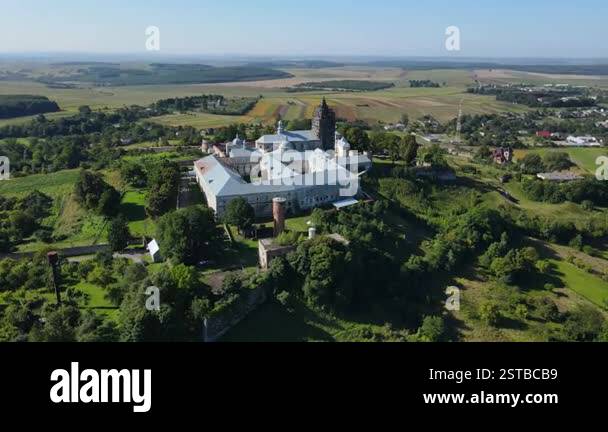 A scenic aerial view of a historic monastery with white roofs and a ...