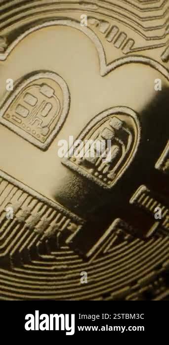 Vertical video. Bitcoin Coin Rotates and Gradually Falls Against a ...