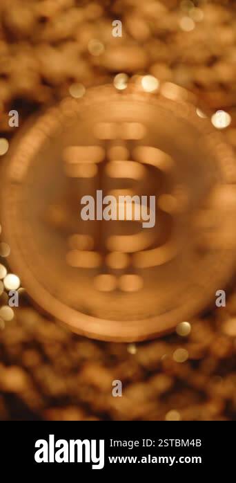 Vertical video. Bitcoin Coin Emerging from Blur to Clarity on Gravel ...
